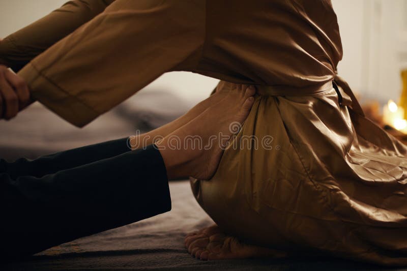 Masseuse Pushing Lower Back with Feet Stock Photo - Image of open ...