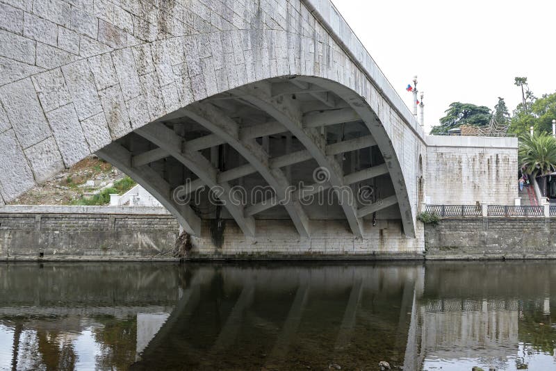 The Massive Arch of the Stone Bridge Over the River. Stock Image ...