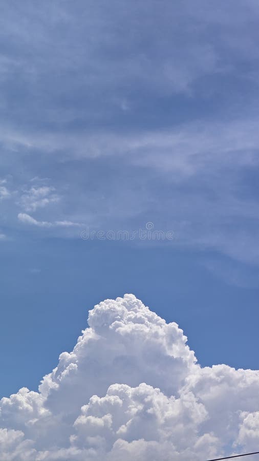 Massive Cumulus Cloud Towers Upward, Glowing Under the Sunlight with a ...