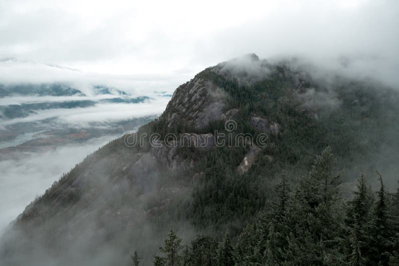 The Massive Granite Rock Appears through the Mist Stock Photo - Image ...