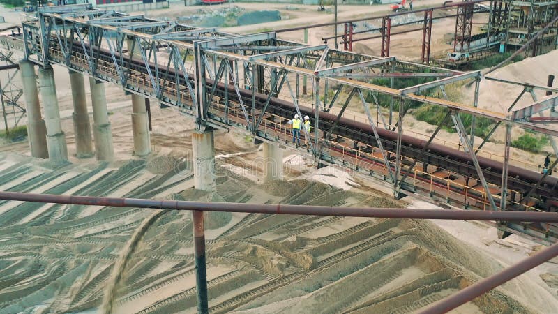 Massive Metal Construction with Two Engineers in the Quarry Zone Stock ...