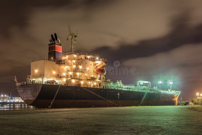 Moored Oil Tanker at Night with a Dramatic Cloudy Sky, Port of Antwerp ... Moored Oil Tanker at Night with a Dramatic Cloudy Sky, Port of Antwerp ...