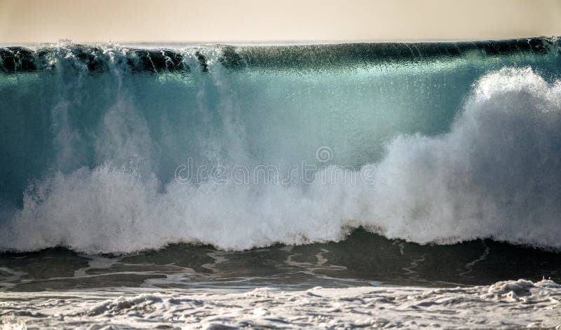 Huge Waves Come Crashing Down, Causing a Back Lit Green Hue As the Wave ...