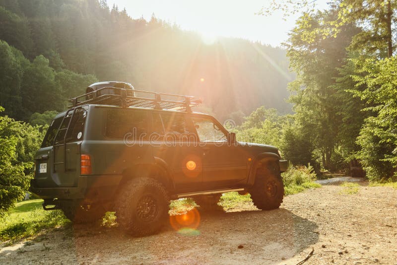 Massive 4x4 Off-road Car on the Dirty Ground in Mountains with Sun ...