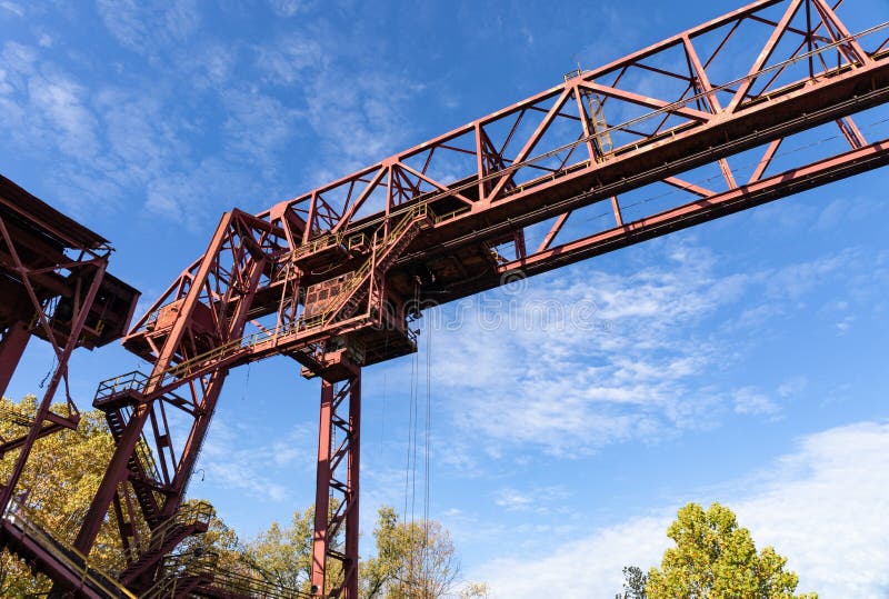 Massive Overhead Steel Structure Silhouetted Against a Bright Blue Sky ...