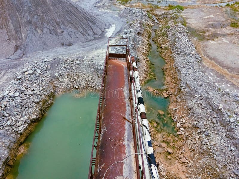 A Massive Cut Out at a Rock Quarry in Winter with Snow Melting Stock ...