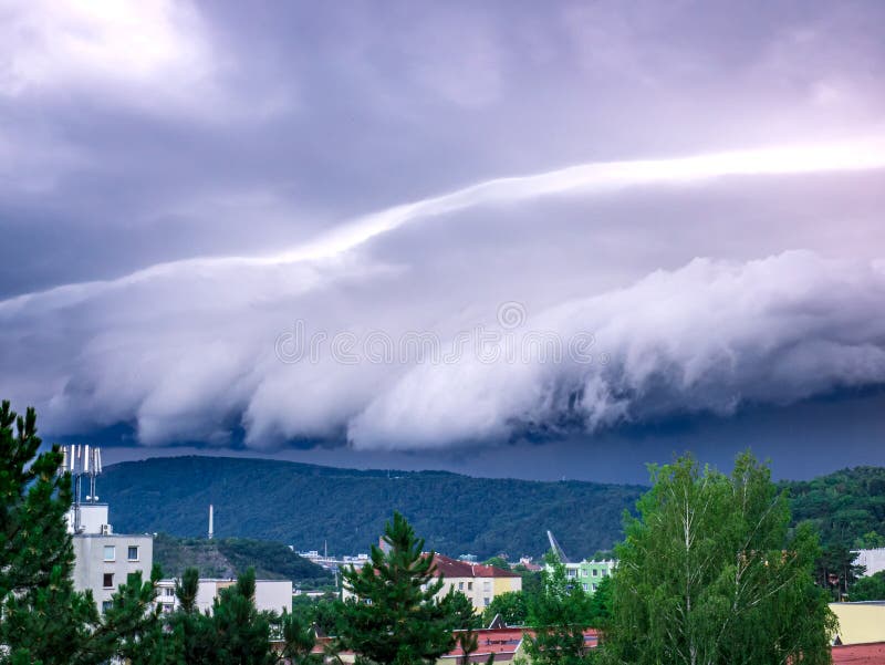 A Massive Shelf Cloud, Arcus Cloud, is Slowly Rolling Over the Hill ...
