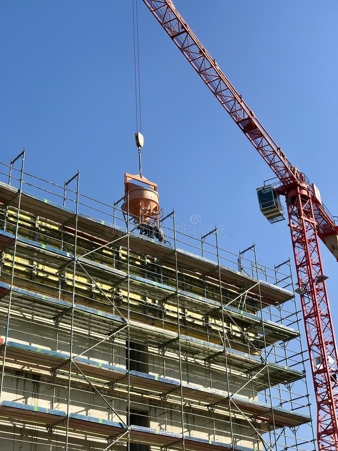A Massive Structure Being Built with Scaffolding and a Crane. Constructing Building of a ...