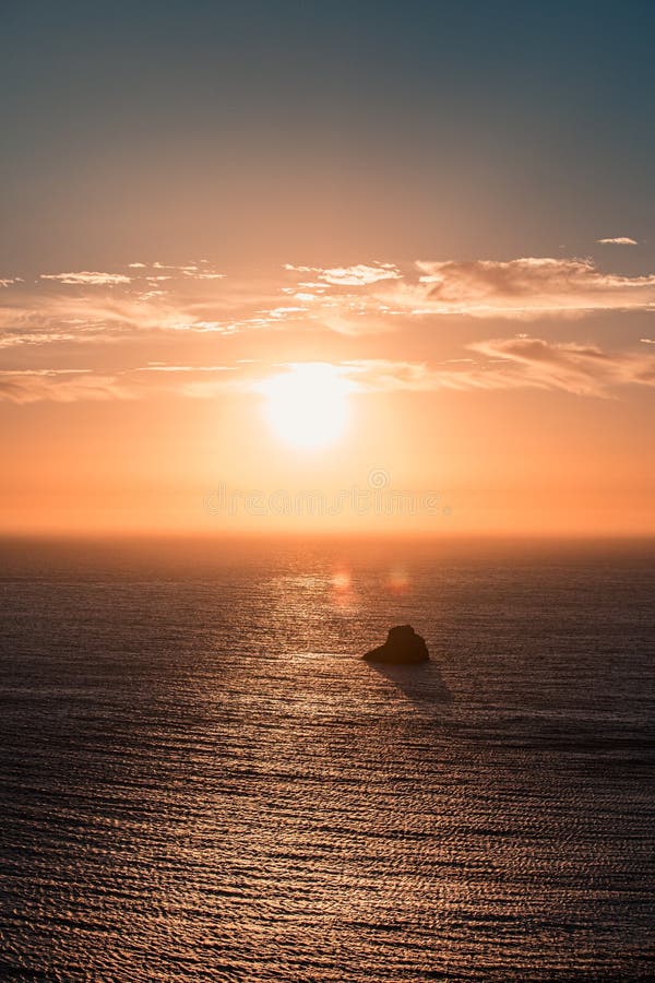 A Massive Sunset Over the Horizon on the Coast Stock Image - Image of ...