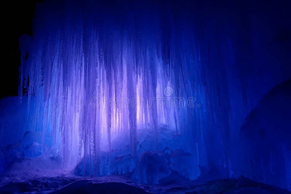 A Massive Wall of Long Ice Stalactites are Illuminated by a Few Rays of ...