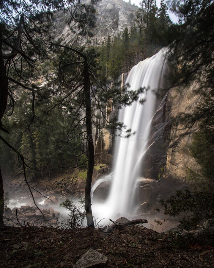 Massive Waterfall Cascading Down a Mountain Face on a Dramatic Cloudy ...