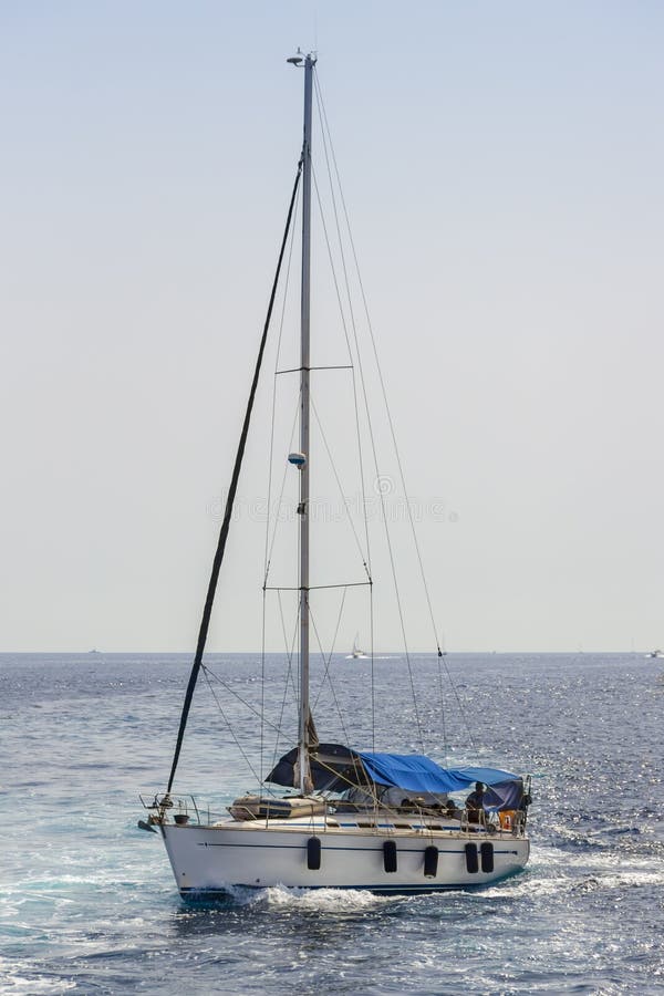 Small One-masted White Catamaran On The Sandy Beach On A Cloudy Day ...