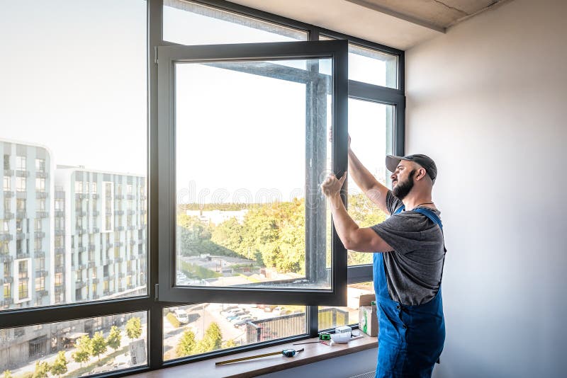 Master Adjusting Pvc Windows with Screwdriver. Installation of Plastic ...