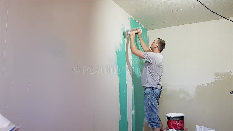 Master is Applying White Putty on the Wall. Putty Application ...