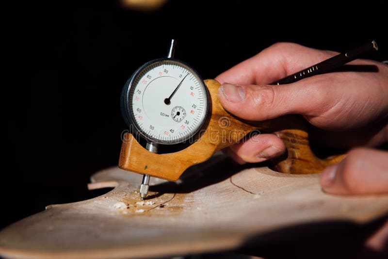 Master Artisan Luthier Working on the Creation of a Violin. Painstaking ...