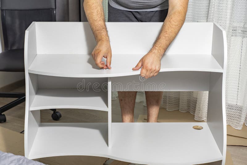 A Man Assembles a New Shelf at Home Stock Photo - Image of furniture ...