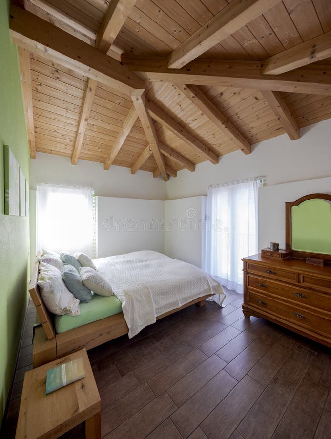 Master Bedroom With Large Bed Nightstand Green Walls And Exposed