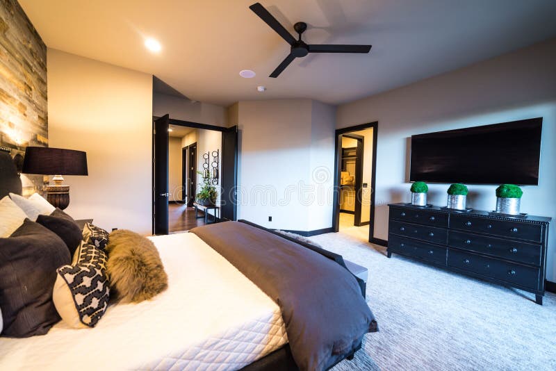 Master Bedroom with Large TV Stock Image - Image of space, bedspread ...