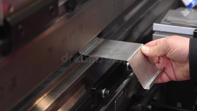 A Master Bends Metal Sheets on a Machine. Hydraulic Press. Stock ...