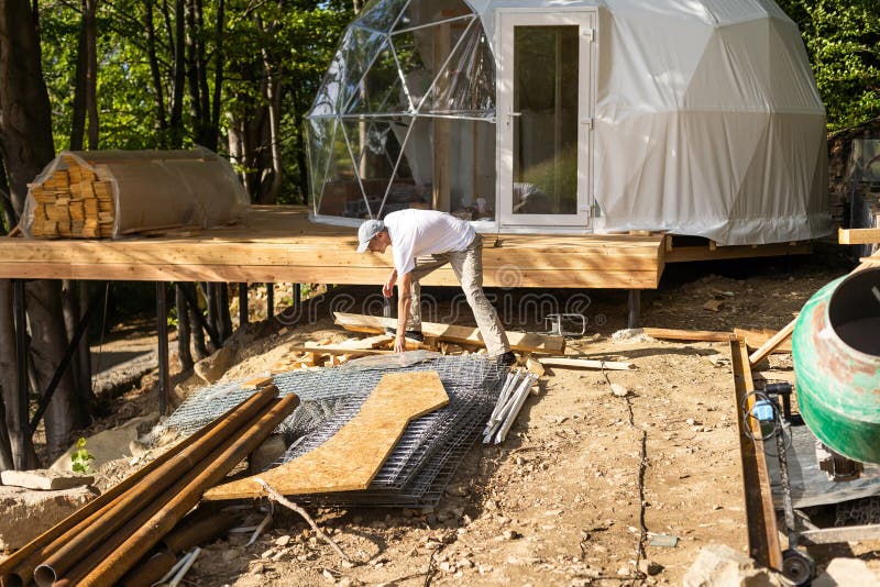 The Master Builds the Dome. Outside Spherical Glamping Dome ...