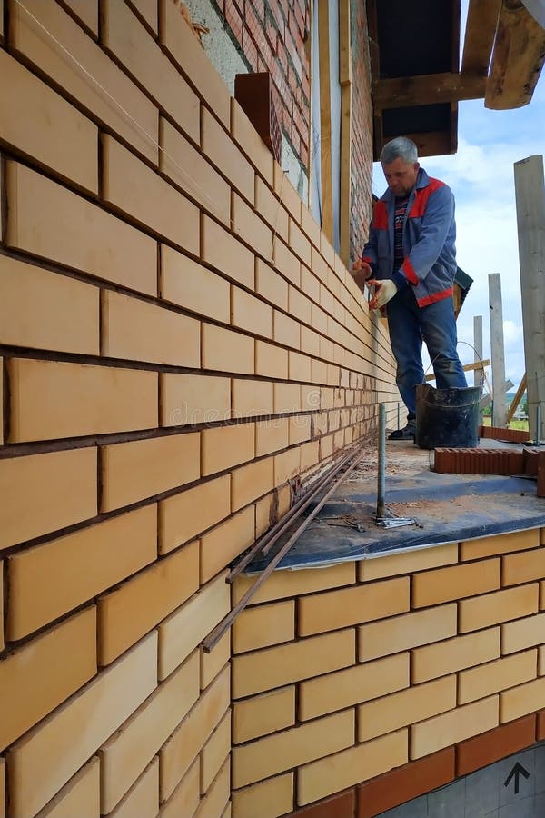 The Master Builds a Wall of a House from a Front Brick Stock Image ...