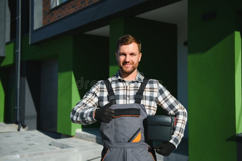 Master on Call. a Plumber or Builder is Standing Near a House. Stock ...