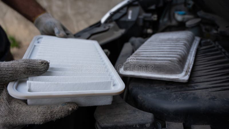 The Master Changes the Air Filter in the Car Engine. Stock Photo ...