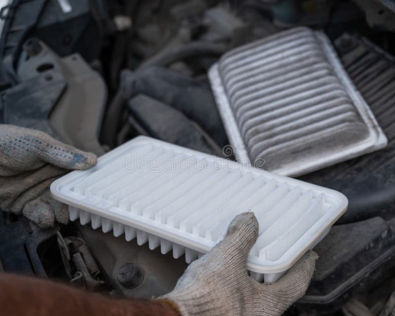 The Master Changes the Air Filter in the Car Engine. Stock Photo ...