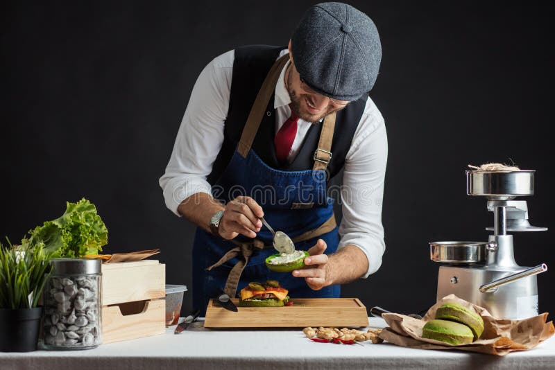 Cook Preparing Burger Adding the Sauce on Green Bun. Stock Photo ...