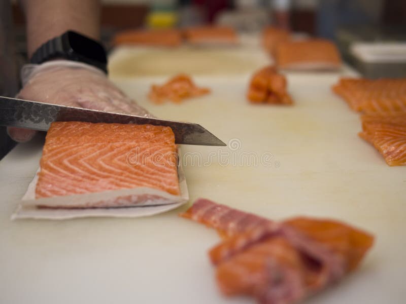 The Master Chef Cuts Salmon with a Special Knife Ensuring Each Piece is ...