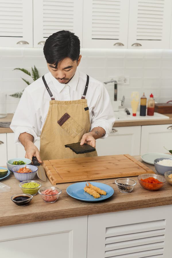 Master Chef Makes Sushi Rolls with Nori. Asian Chef on Kitchen, Food ...