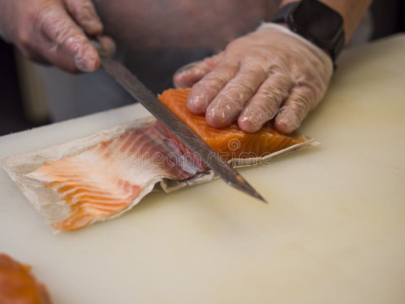 The Master Chefs Hands Move with Precision As he Cuts Salmon into ...