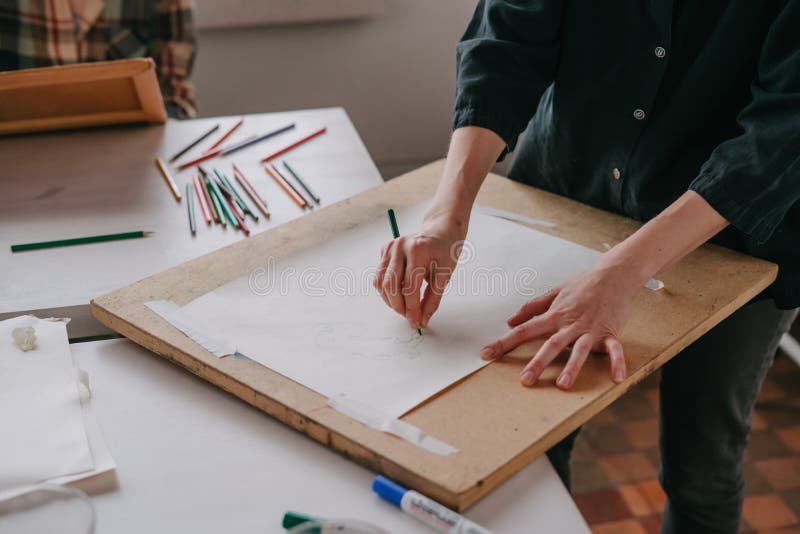 The Girl is in the Process of Drawing. Sketching with a Colored Pencil ...