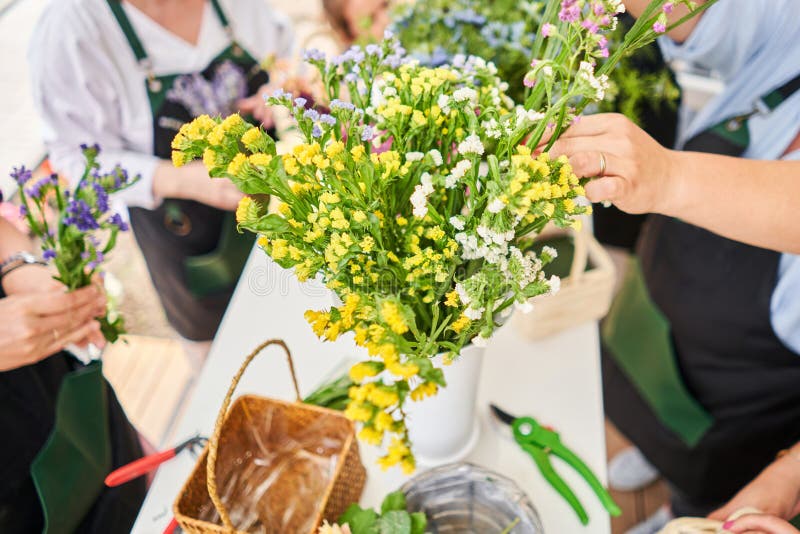 Master Class on Making Bouquets. Spring Bouquet in Wicker Basket Stock ...