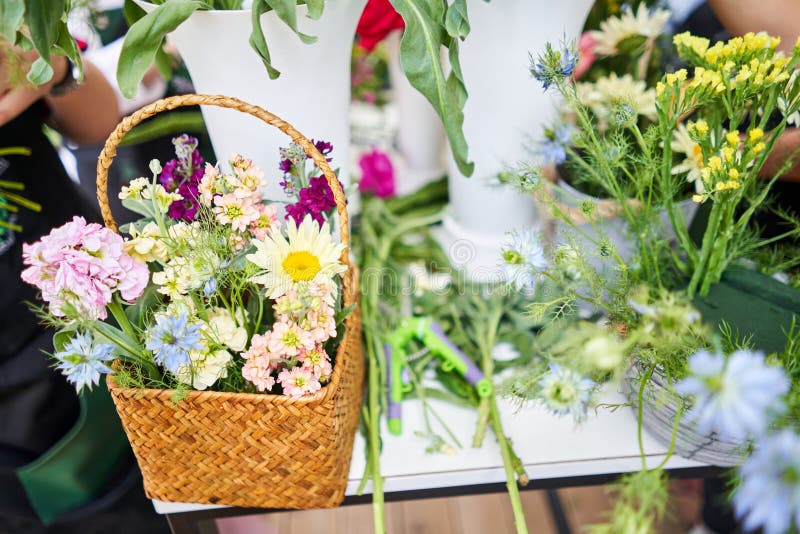 Master Class on Making Bouquets. Spring Bouquet in Wicker Basket Stock ...
