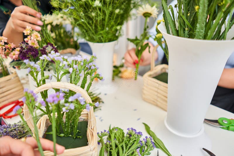 Master Class on Making Bouquets. Spring Bouquet in Wicker Basket Stock ...