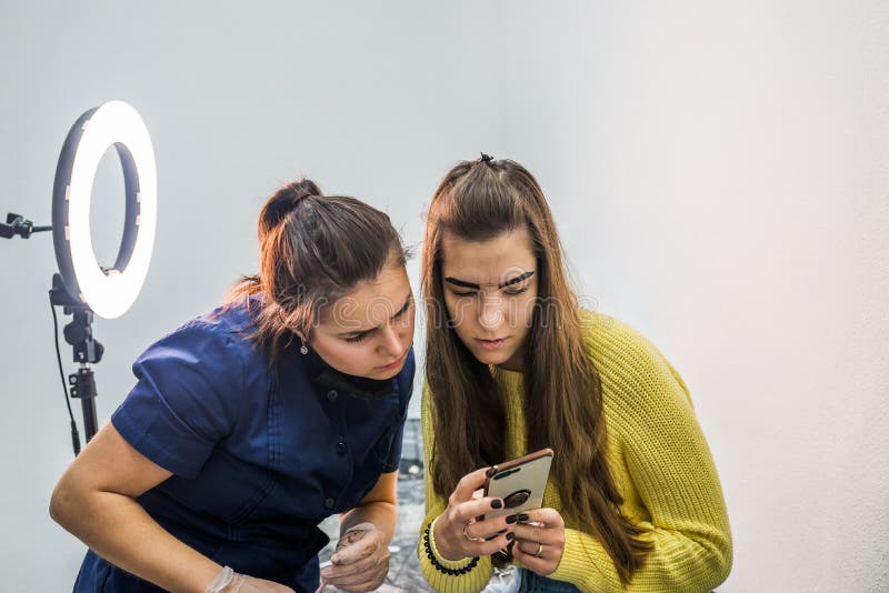 The Master and the Client in the Beauty Salon Look in the Mirror Stock ...