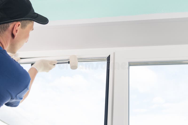Master Clogs with a Rubber Mallet a Fastener for a Double-glazed Window ...