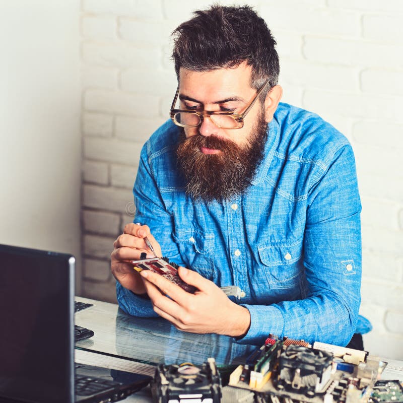 Master of Computers. Bearded Hipster Works on Fixing Digital Hardware ...