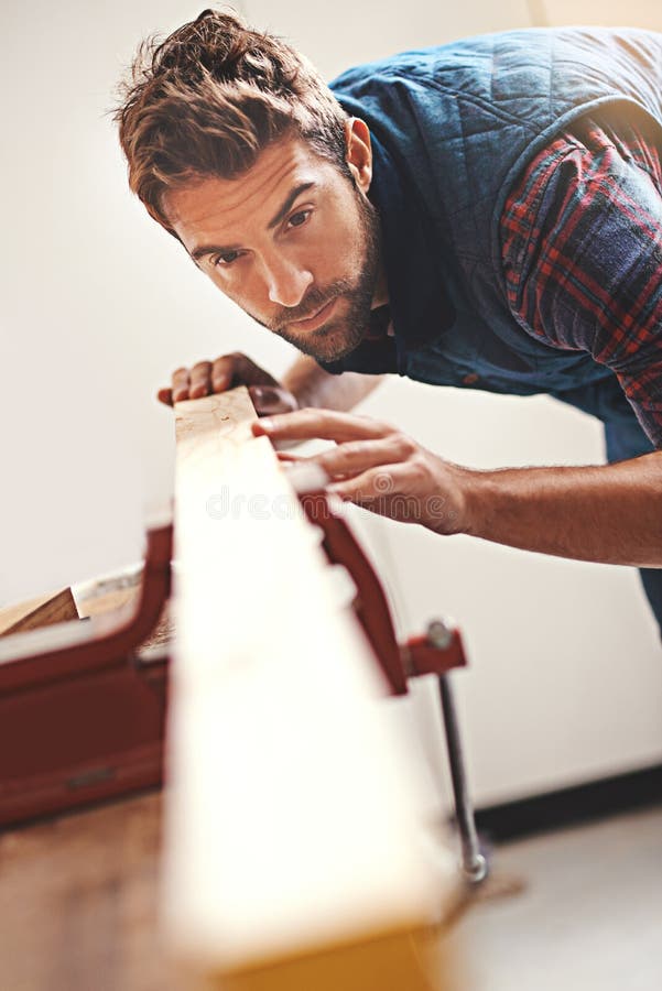 Master Crafter at Work. a Carpenter Working on a Plank of Wood in His ...