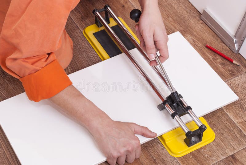 Master cuts the tile stock image. Image of cutting, installing - 88231047