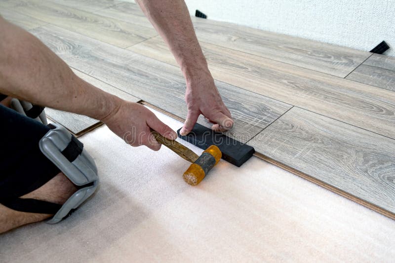 The Master Does the Work of Laying the Floor Laminate, a Special Tool ...
