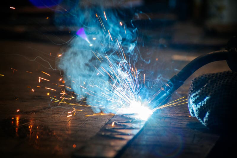 Master is Doing Welding at His Workplace in the Workshop, while Sparks ...