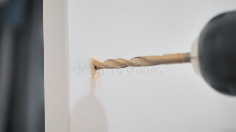 The Master Drills a Hole in the Wall with a Drill, Inserts a Screw ...