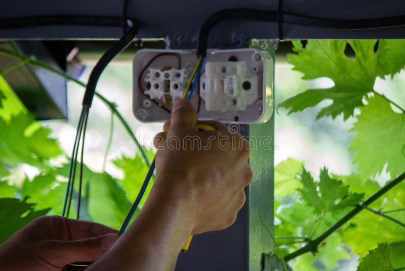 A Master Electrician Installs a Socket and a Switch Stock Photo - Image ...