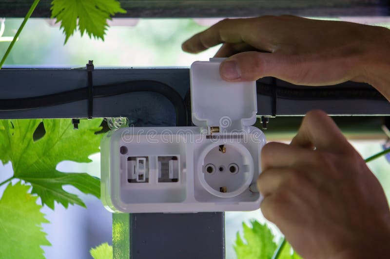 A Master Electrician Installs a Socket and a Switch Stock Photo - Image ...