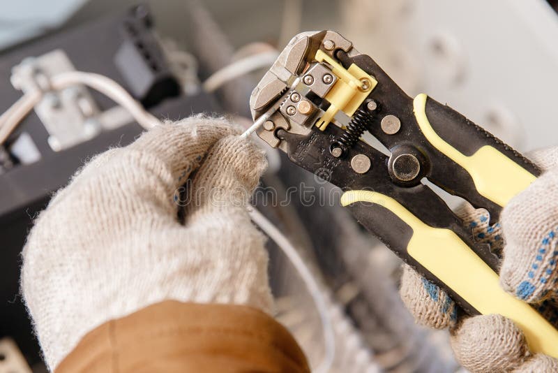 Master Electrician with Professional Tool for Removing Insulation from ...