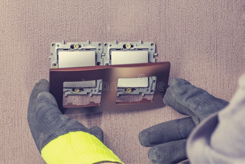 The Master Electrician Sets the Switch. Close-up. the Room is Colored ...