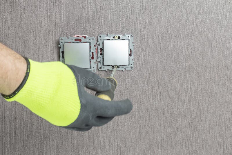 The Master Electrician Sets the Switch. Close-up. the Room is Colored ...
