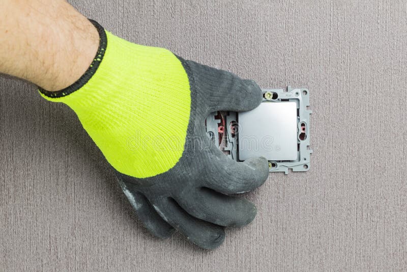 The Master Electrician Sets the Switch. Close-up. the Room is Colored ...